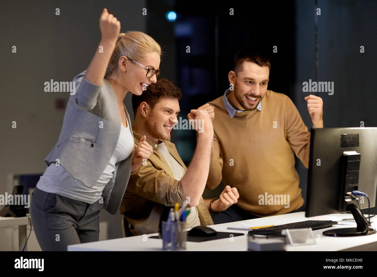 business team celebrating success at night office Stock Photo - Alamy