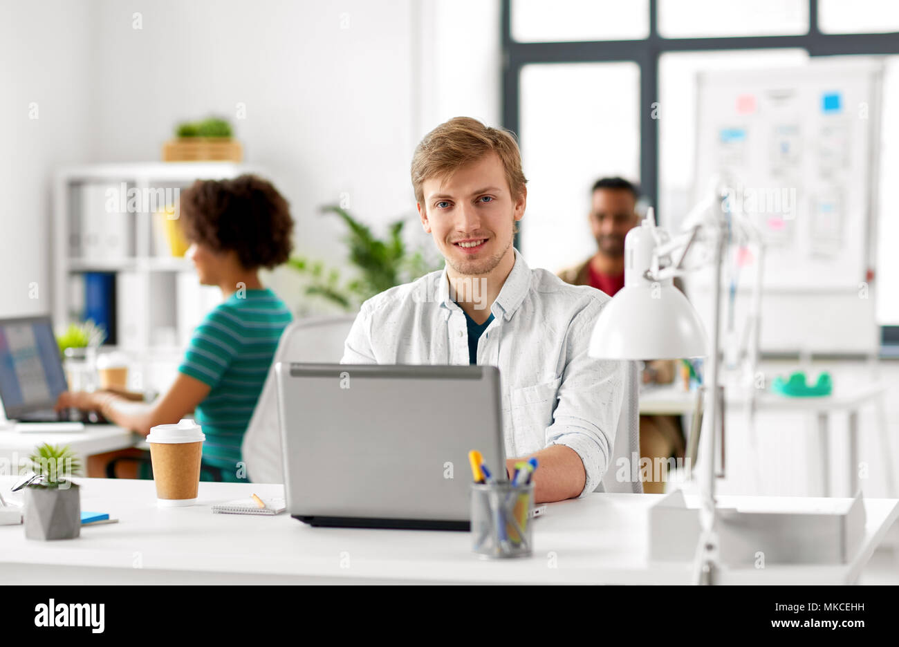 creative male office worker with laptop Stock Photo - Alamy