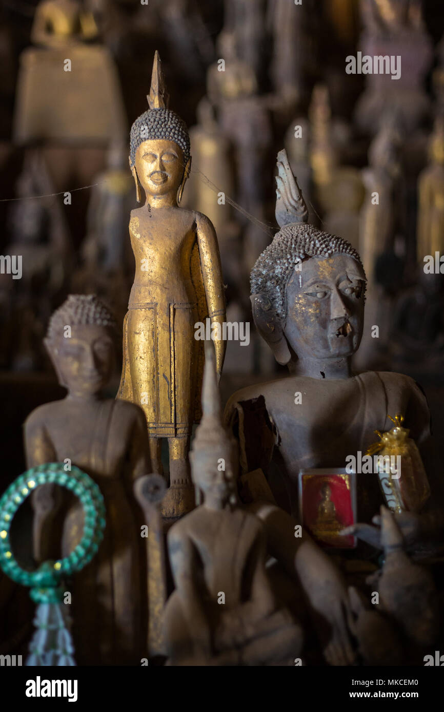 Close-up of several old, golden and wooden Buddha statues inside the ...