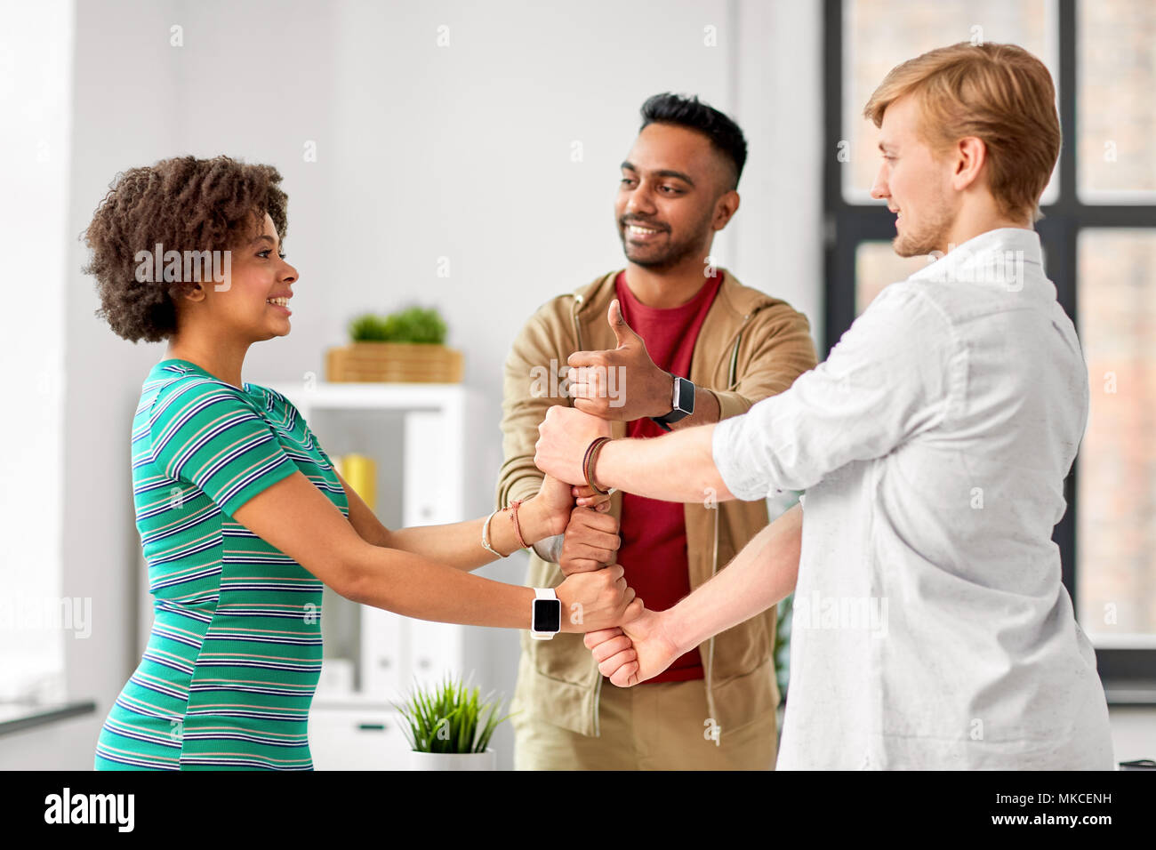 happy creative team making high five at office Stock Photo - Alamy