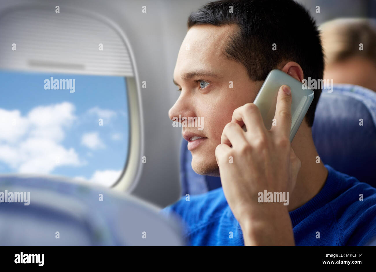 Man talking on phone on plane hi-res stock photography and images - Alamy