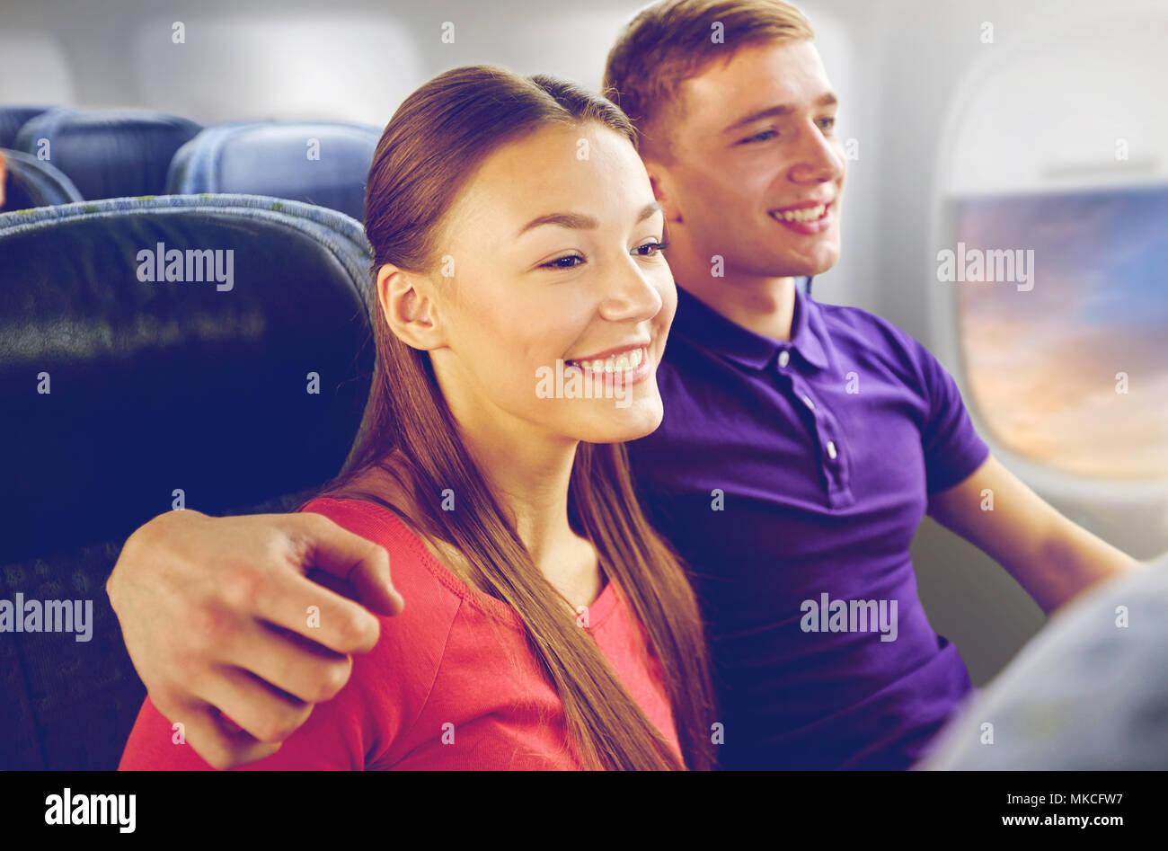 happy couple travelling by plane Stock Photo - Alamy