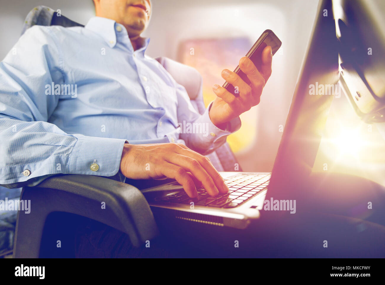 Businessman cell phone plane hi-res stock photography and images - Alamy