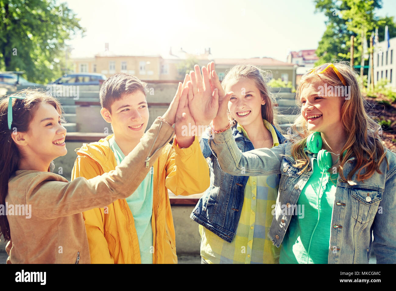 happy students or friends making high five Stock Photo - Alamy