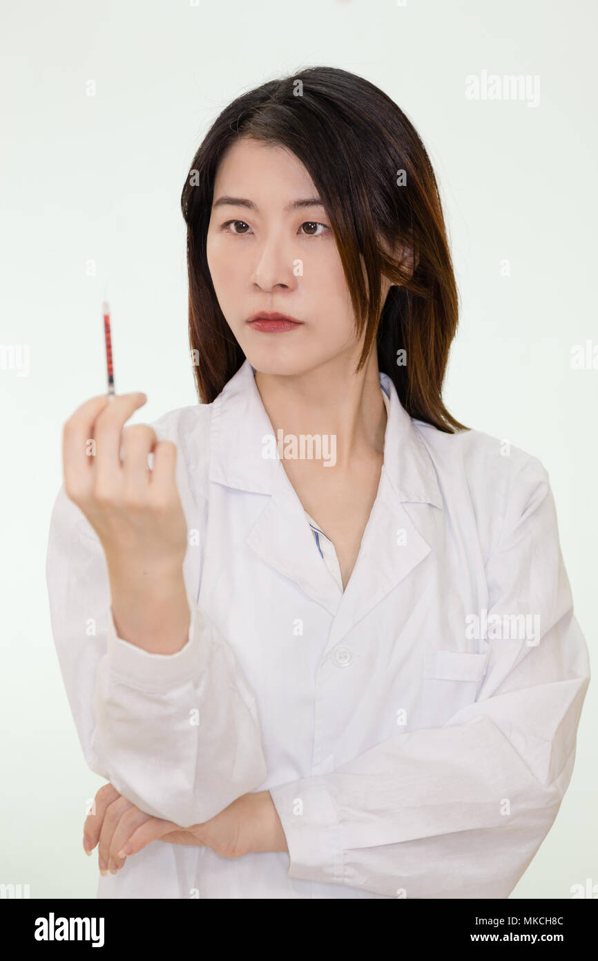 Asian nurse holding a blood-filled syringe in hand Stock Photo - Alamy