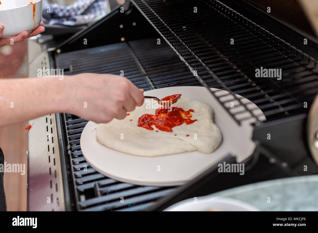 Cooking pizza on outdoor gas grill Stock Photo - Alamy