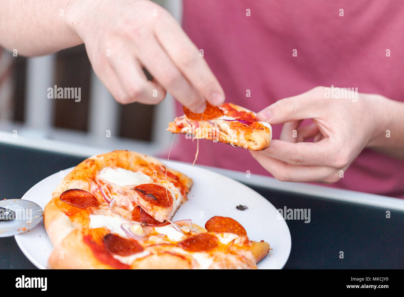 Eating pizza cooked on outdoor gas grill Stock Photo - Alamy