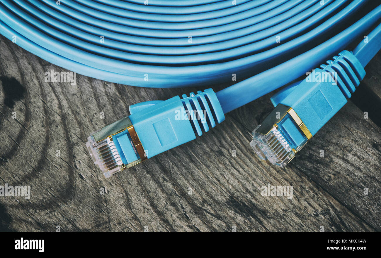 network cable with RJ45 connectors on wooden background Stock Photo - Alamy