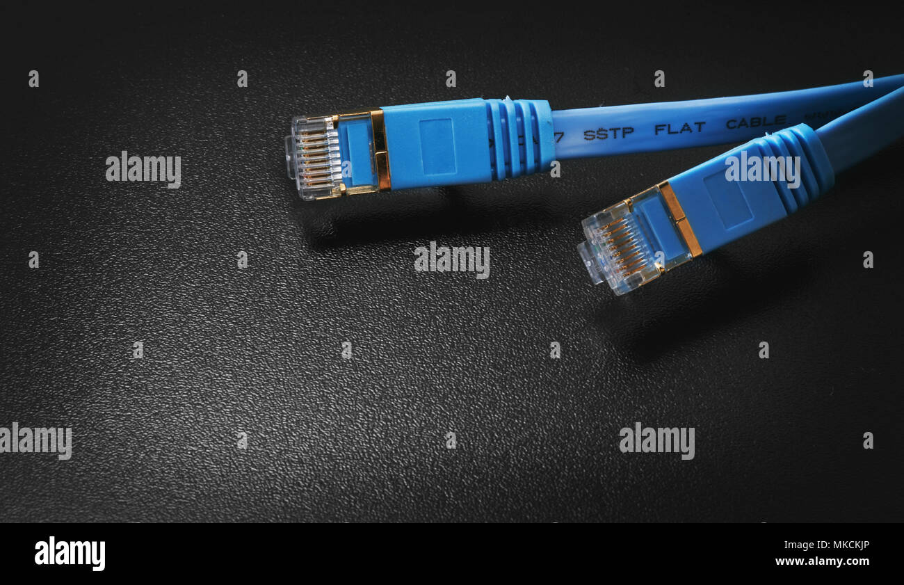 RJ45 wire line. Patch cord cable on black background. Network ...