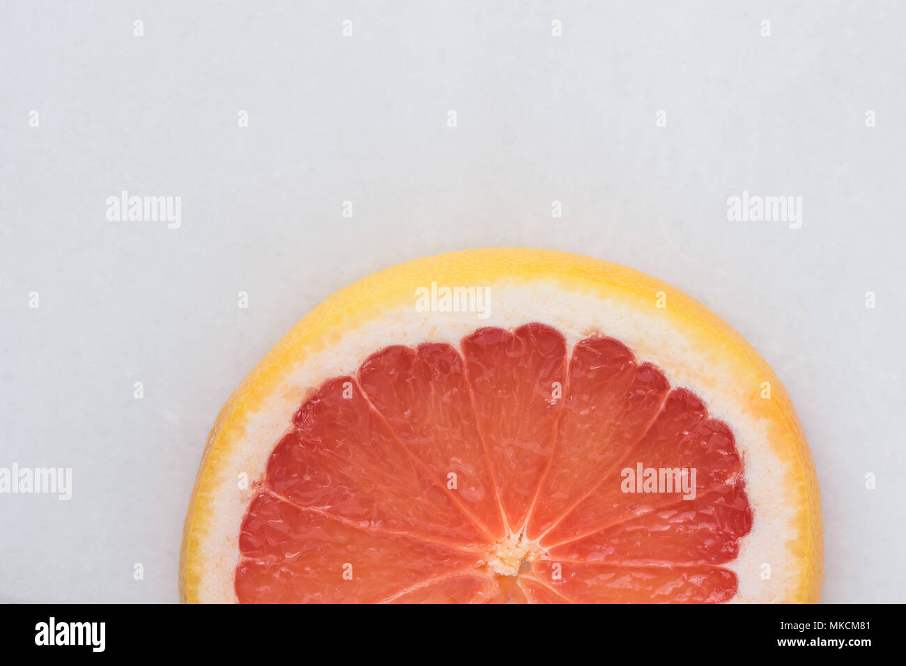 Semi Circle Slice of Ripe Juicy Red Grapefruit on White Stone Marble ...