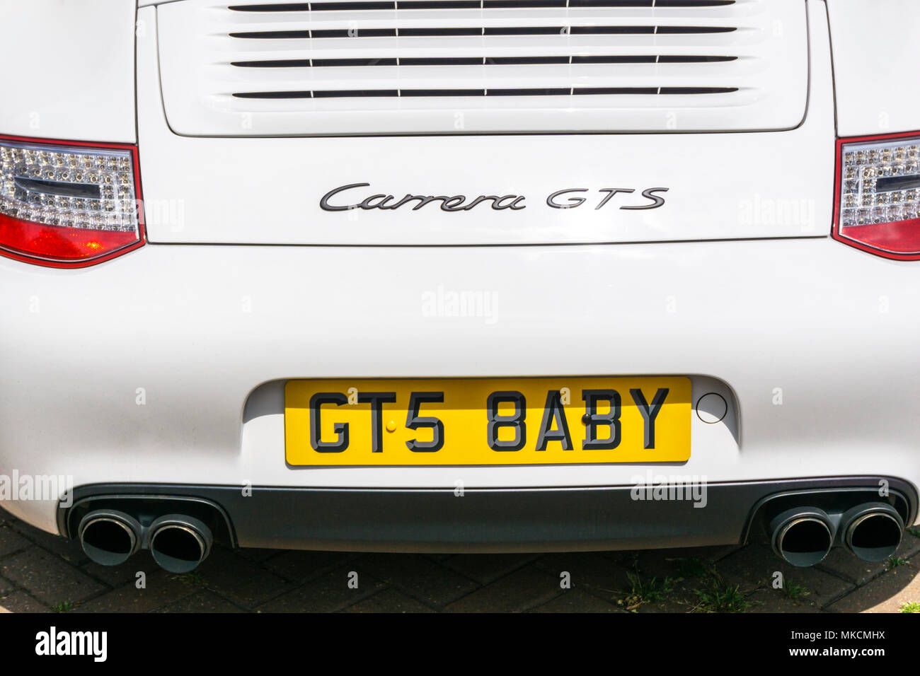 A Porsche Carrera GTS with a personalised number plate that effectively ...