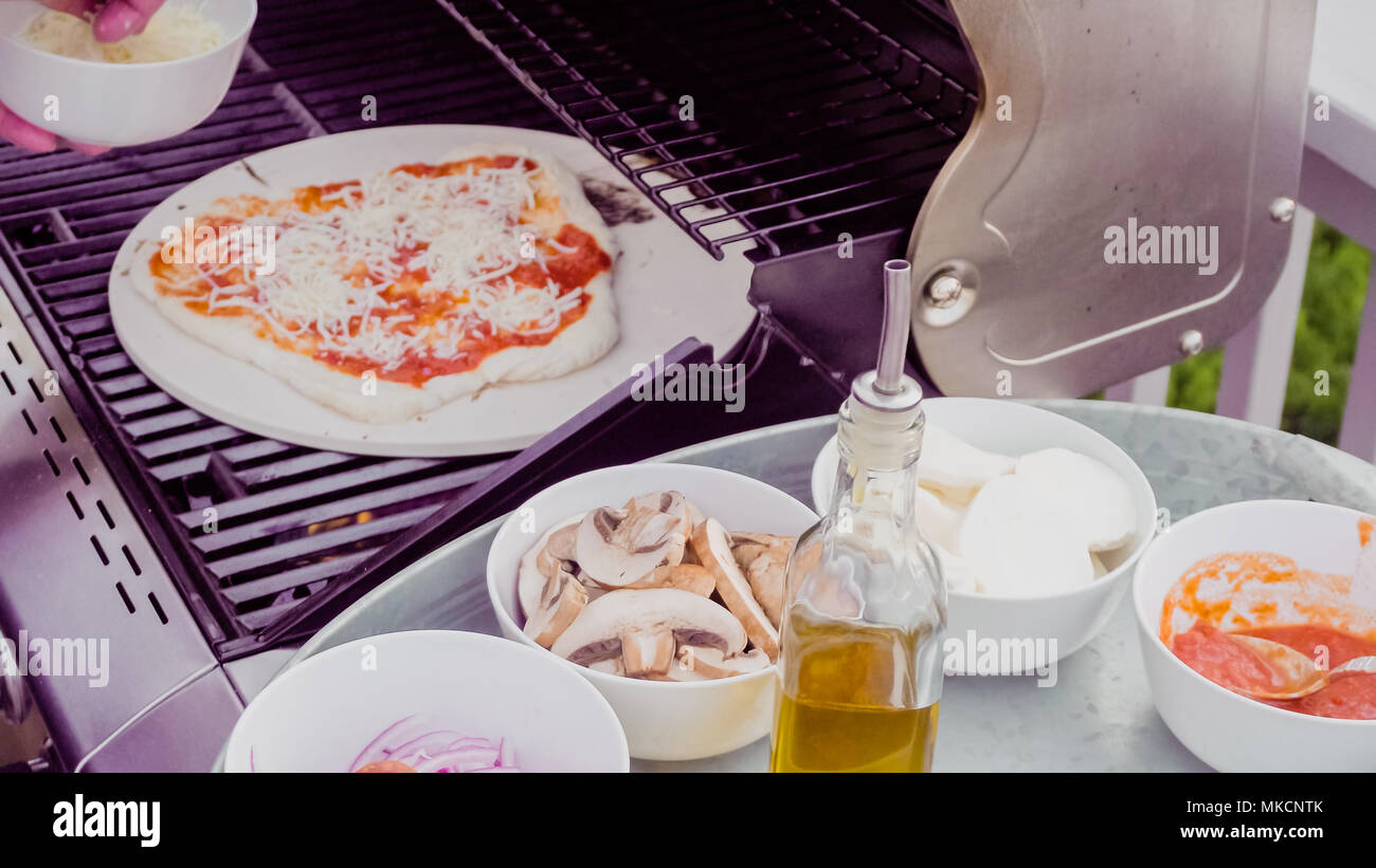 Cooking pizza on outdoor gas grill Stock Photo - Alamy
