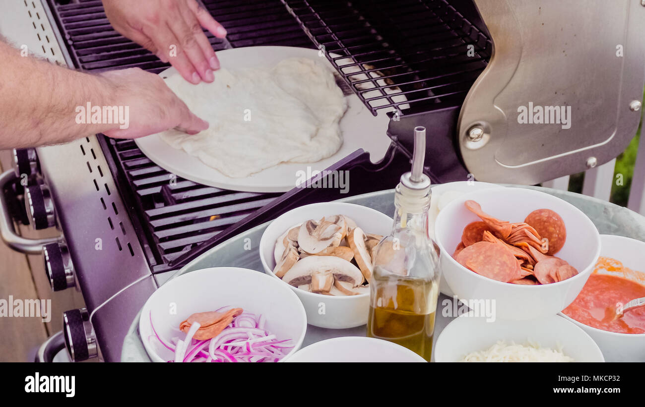 Cooking pizza on outdoor gas grill Stock Photo - Alamy