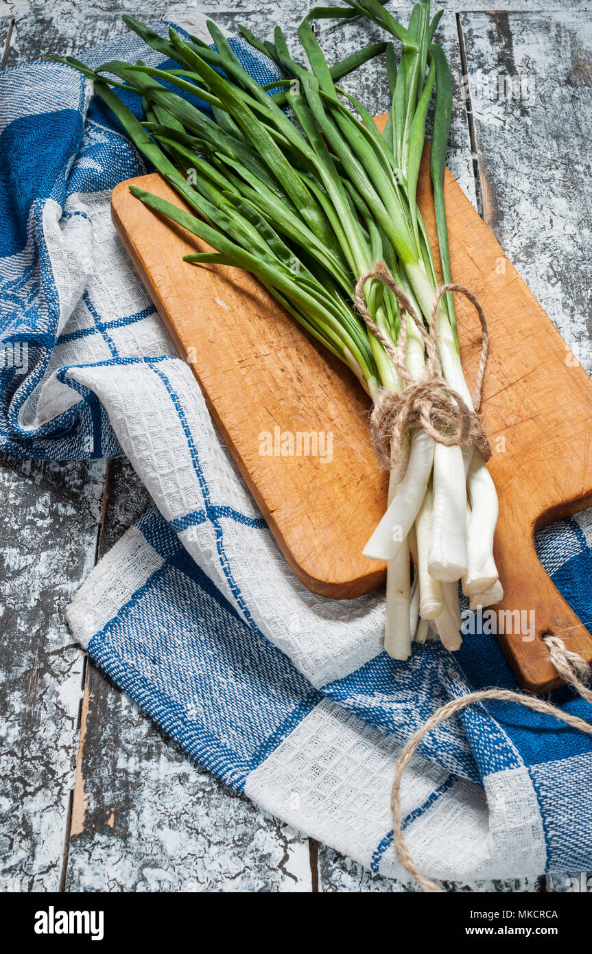 bunch of spring onion on a wood table Stock Photo - Alamy