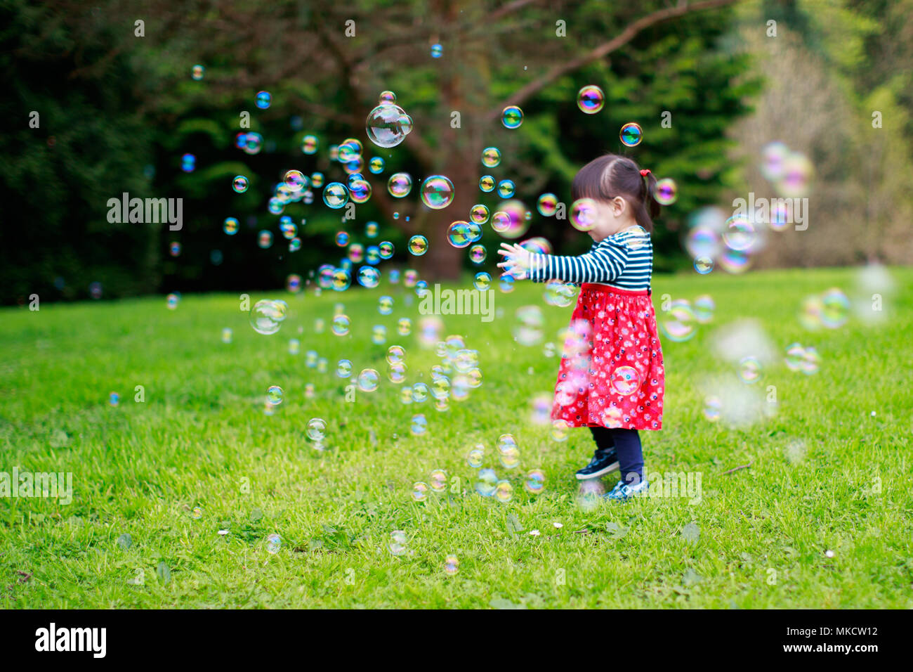 baby girl play bubble at spring garden Stock Photo - Alamy