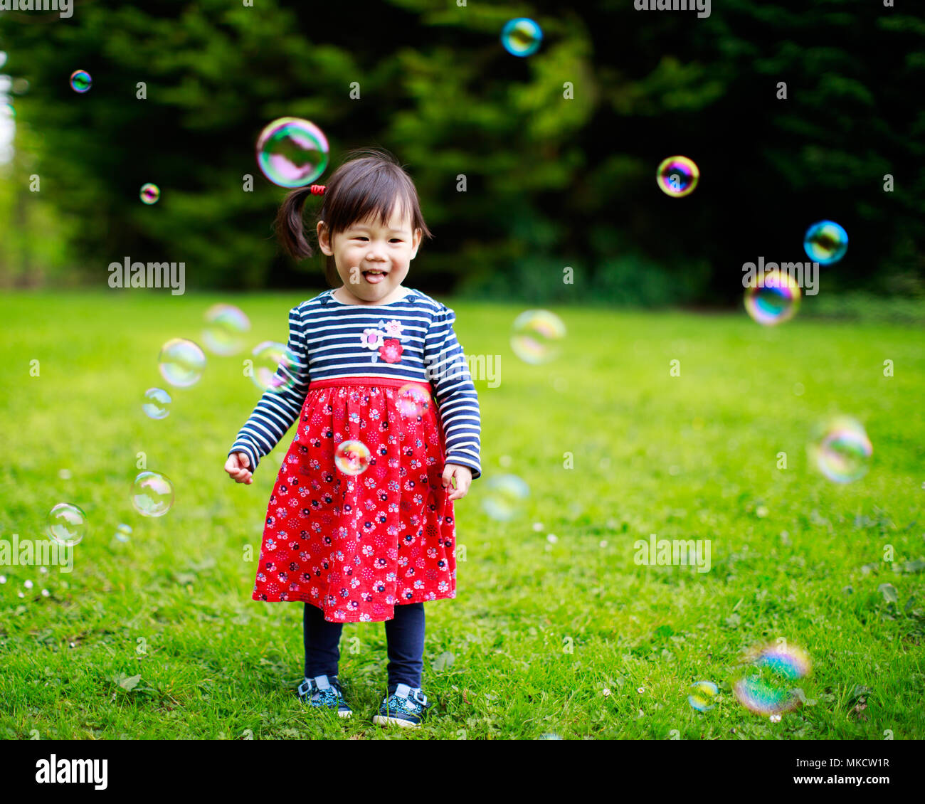 baby girl play bubble at spring garden Stock Photo - Alamy