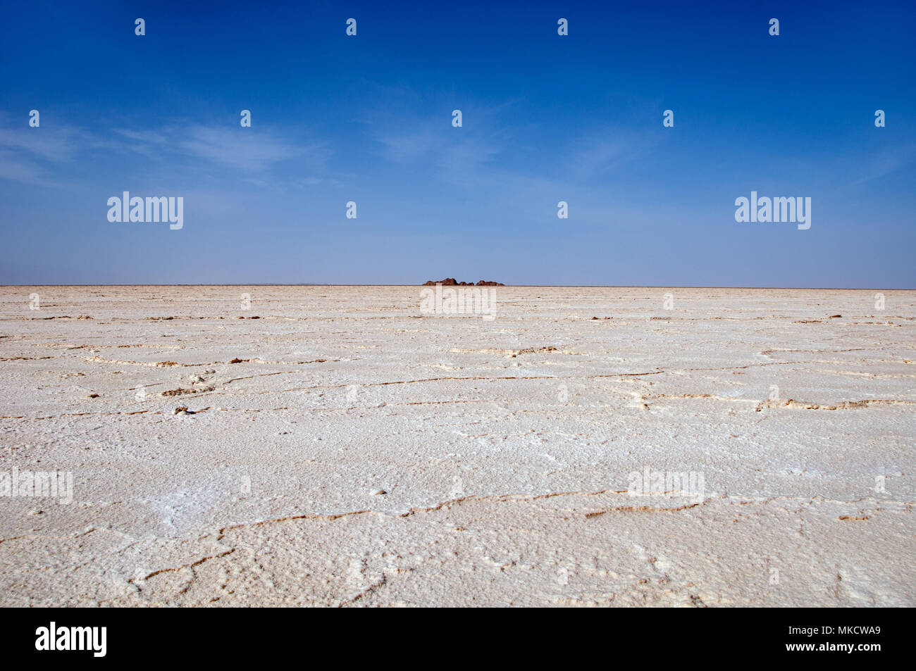 Ideally white soils of Danakil valley solonchaks and blue sky with thin ...