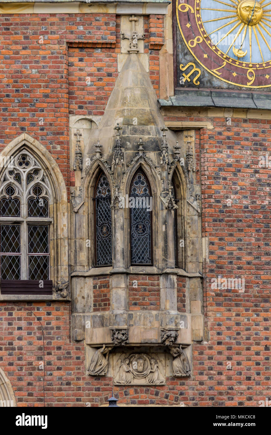 Detail of the facade of the medieval Town Hall. Windows, clocks, stone ...