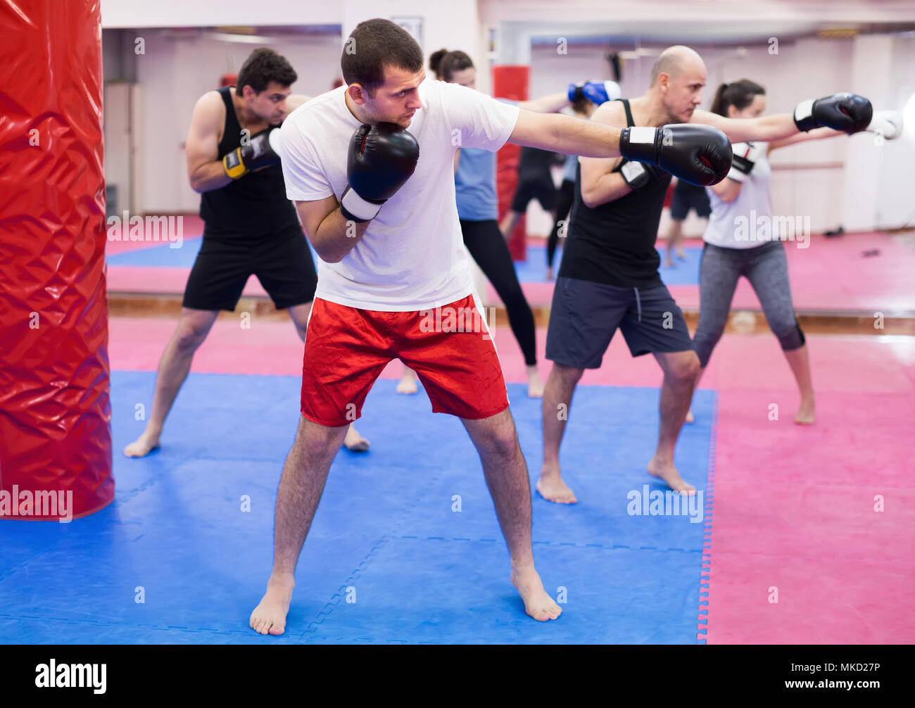 Group of sports men practicing in the boxing hall Stock Photo - Alamy
