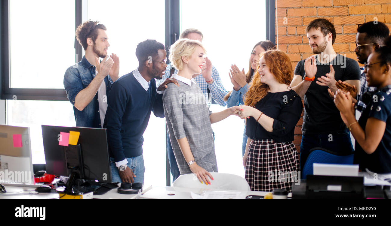 co-workers are congratulating new employee who has done work experience ...