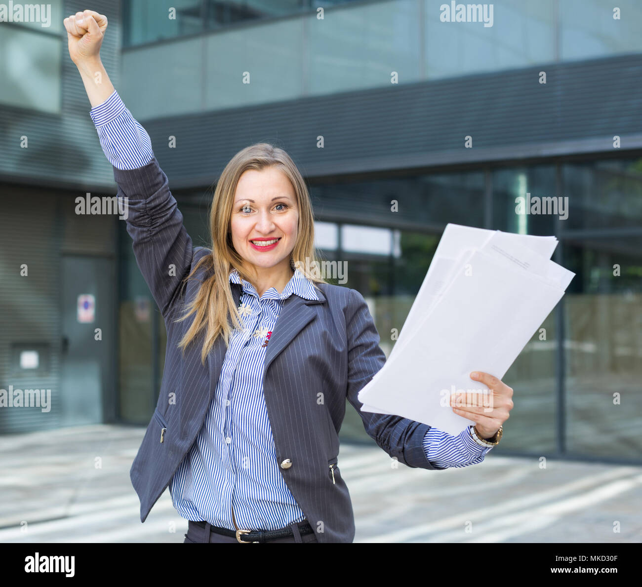 Professional woman in jacket working with documents at the street Stock ...