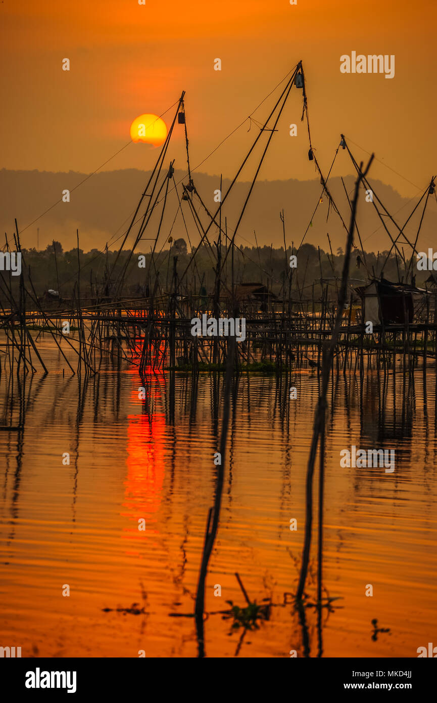 Traditional bamboo and wooden fishing tools installed in rural swamp ...