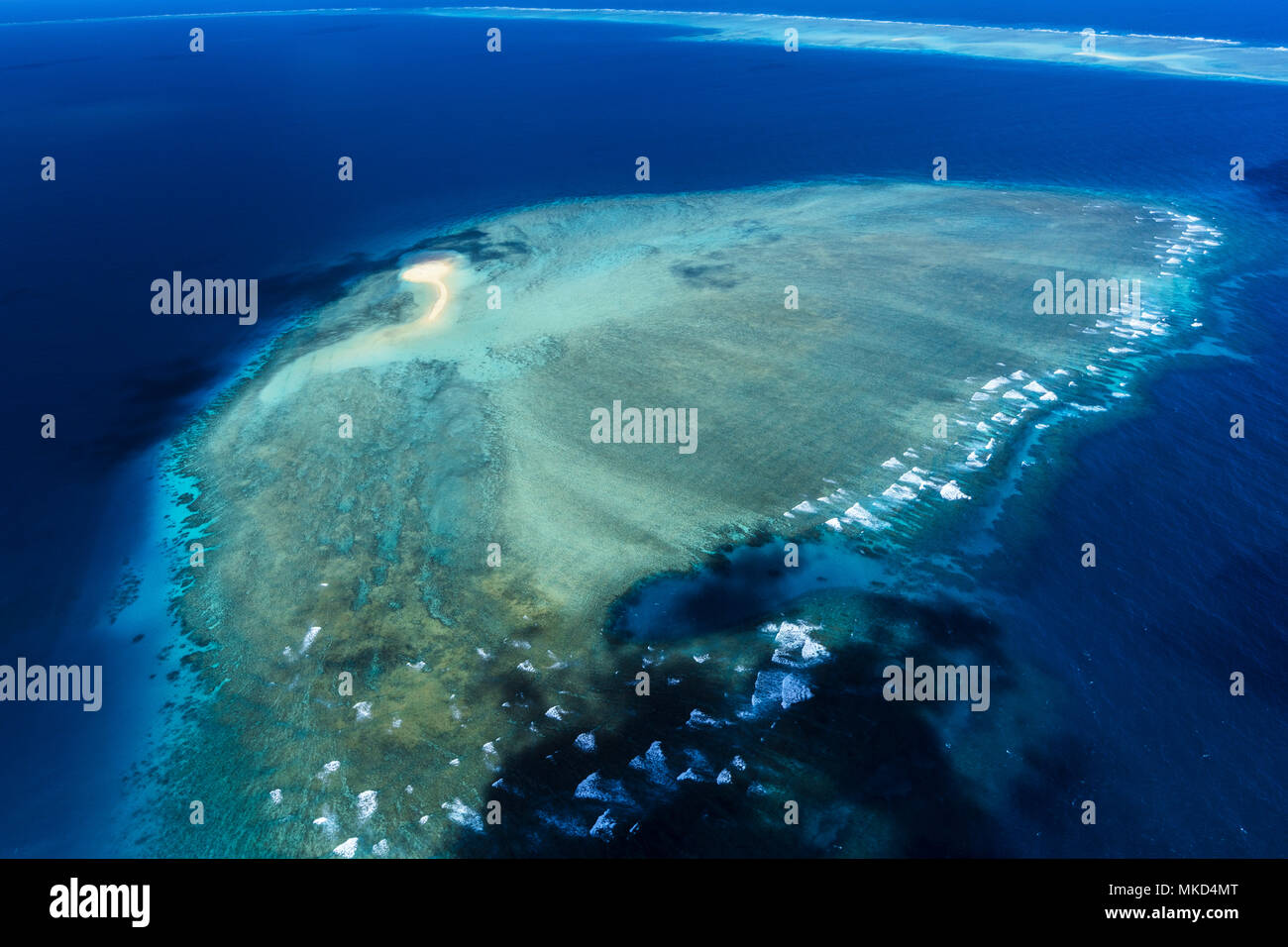 Aerial view of the reef that forms the white sand island of Saziley ...