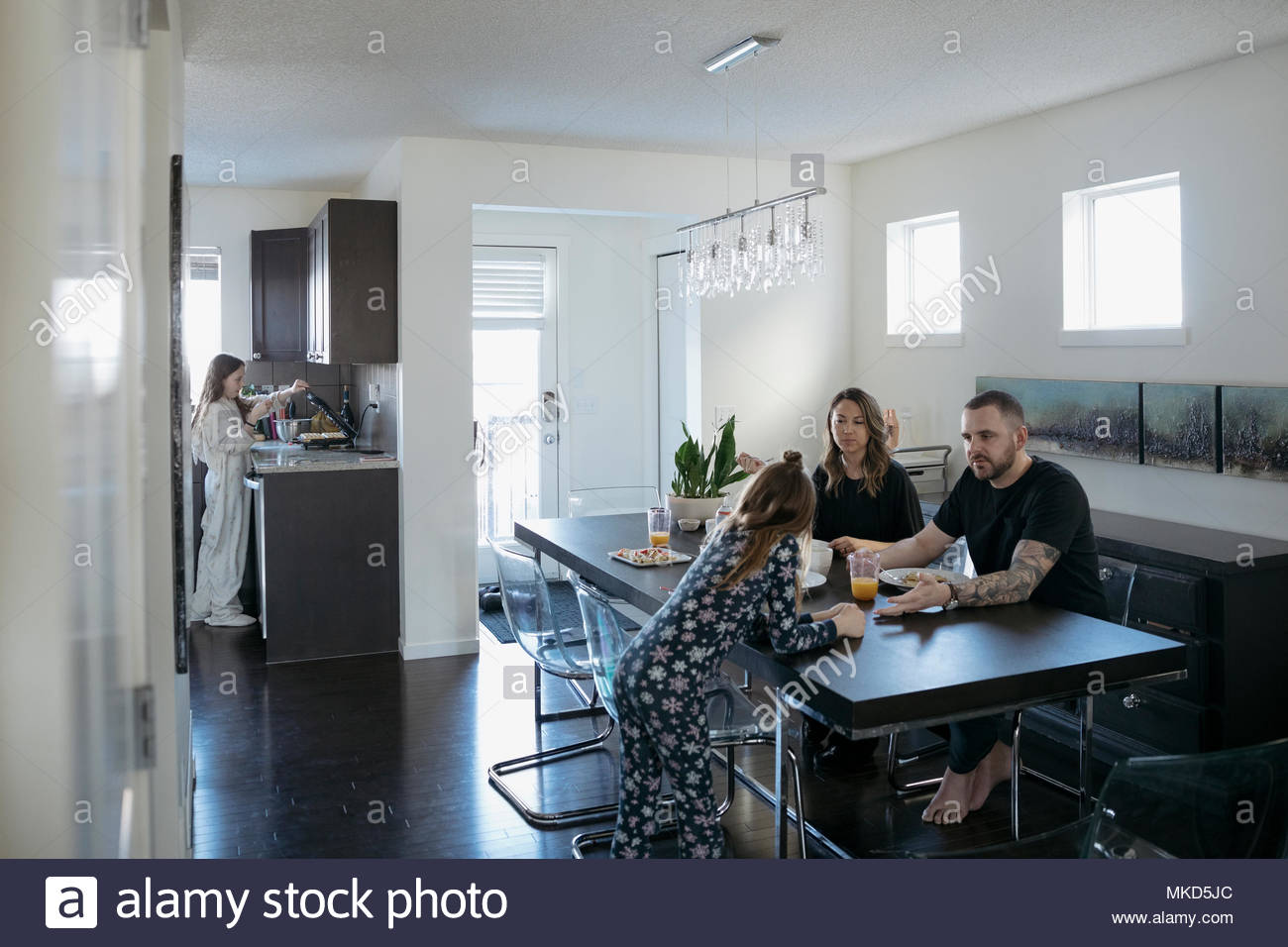 Family eating breakfast at dining table Stock Photo - Alamy