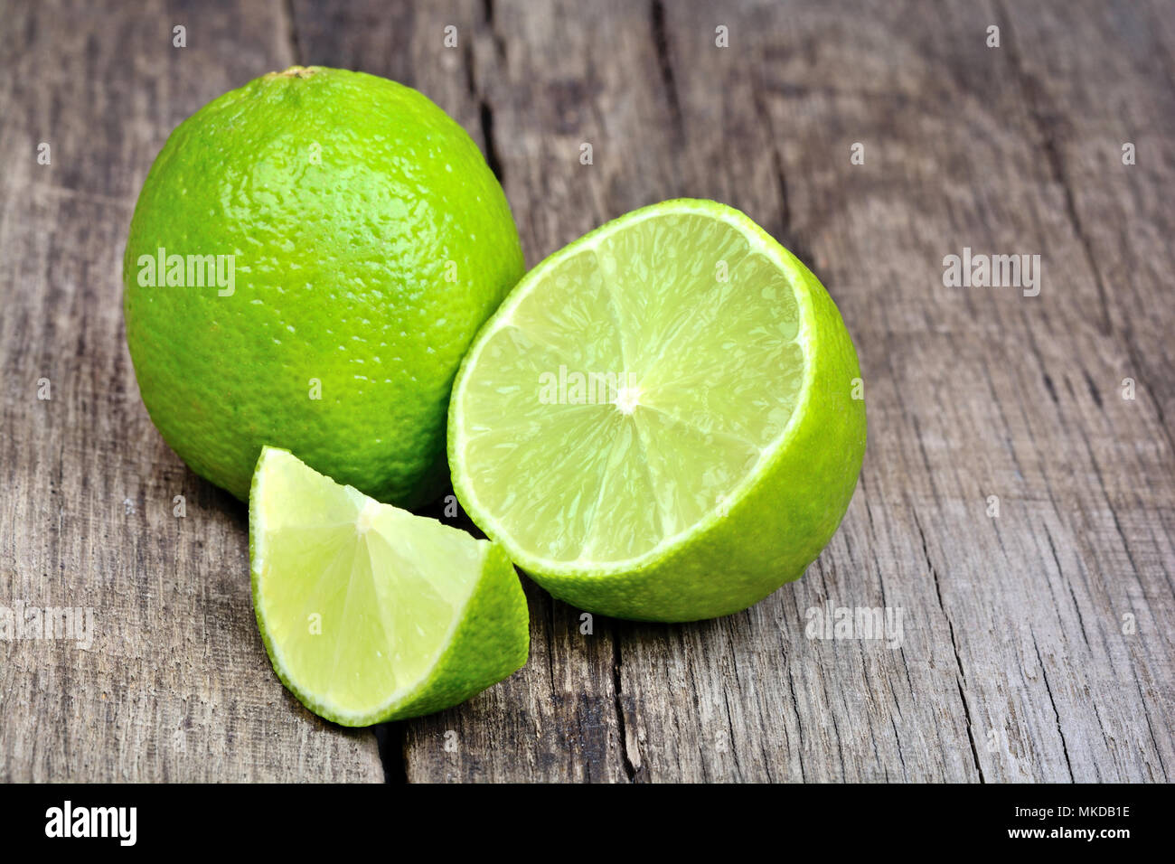 Lime on rustic wood table Stock Photo - Alamy