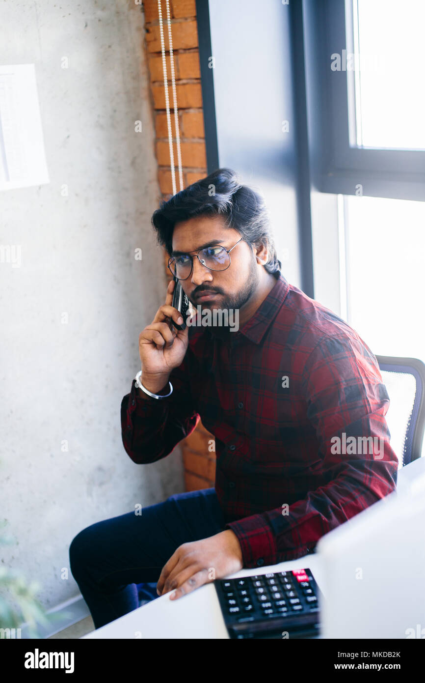 close up side view portrait of handsome bearded man making a phone call ...