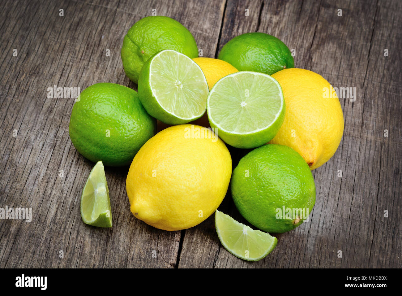 Lime and lemon on a rustic wood table Stock Photo - Alamy
