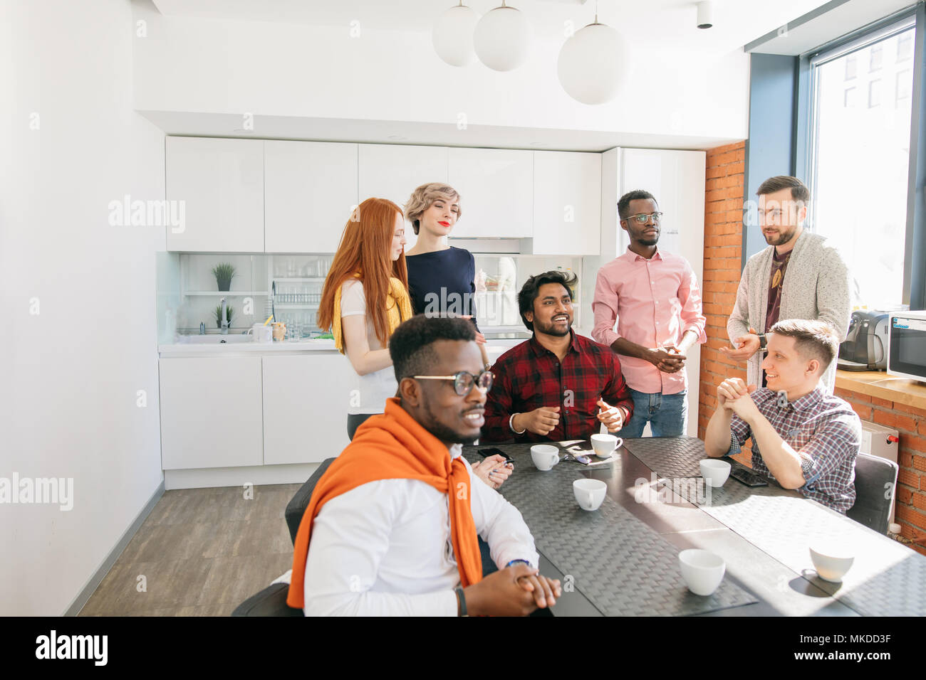 closeup image of young people taking tea at work Stock Photo - Alamy