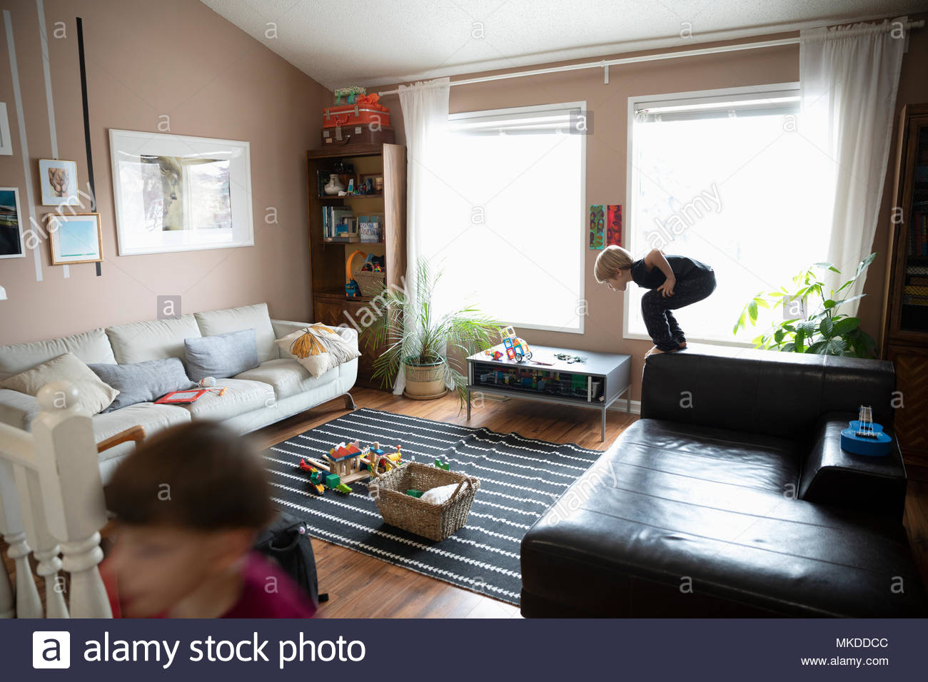 Boy jumping sofa hi-res stock photography and images - Alamy