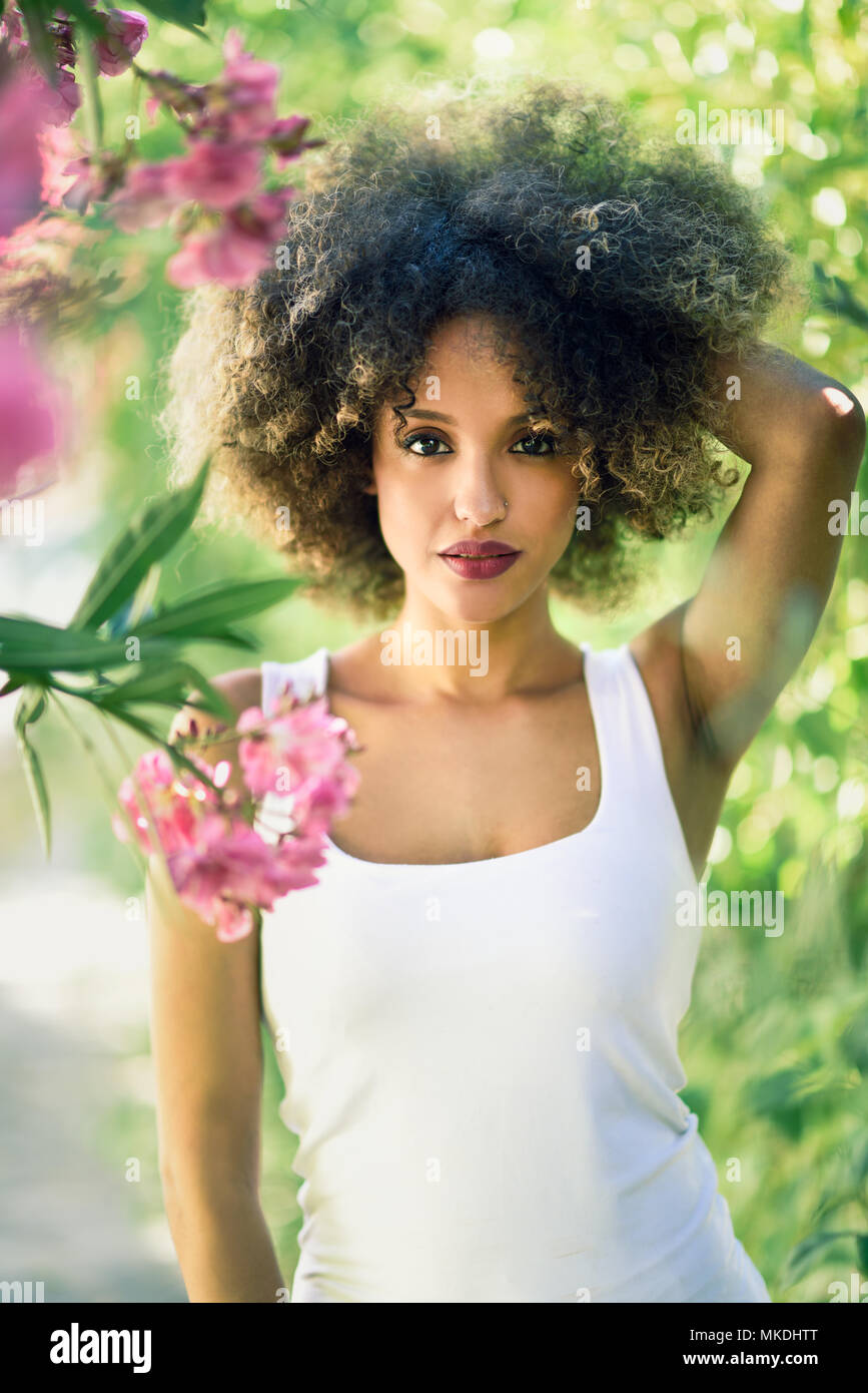 Young Black Woman With Afro Hairstyle In Urban Park Mixed Girl Wearing