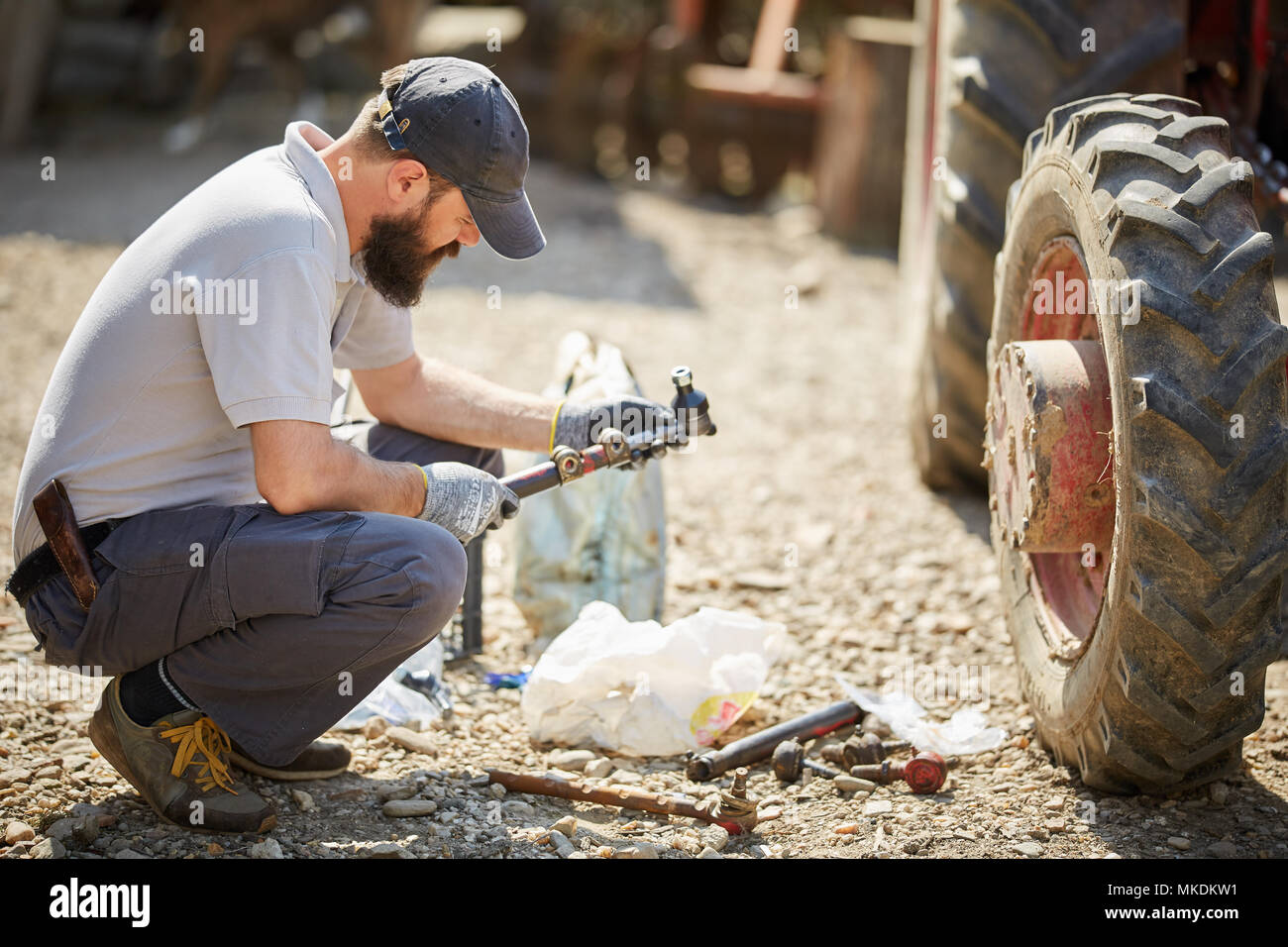 Mechanic repairing tractor hi-res stock photography and images - Alamy