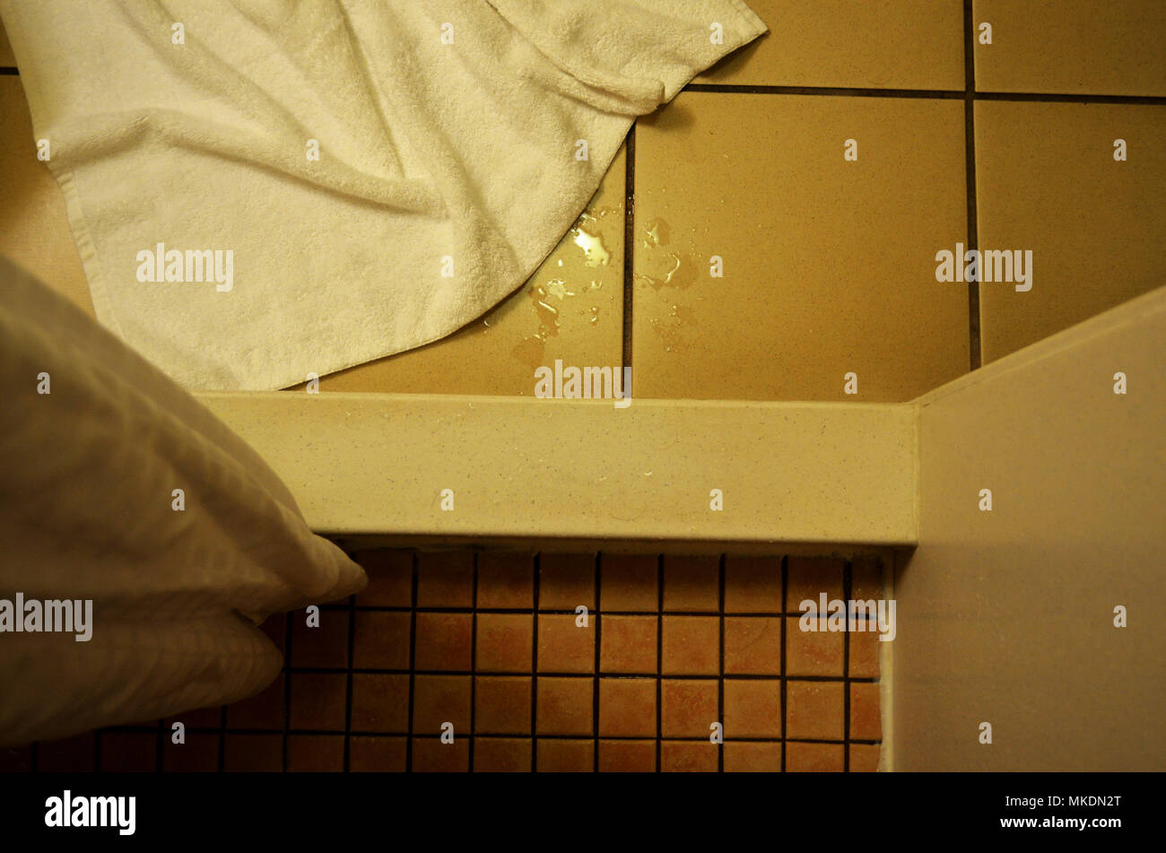 Discarded towel by shower Stock Photo - Alamy