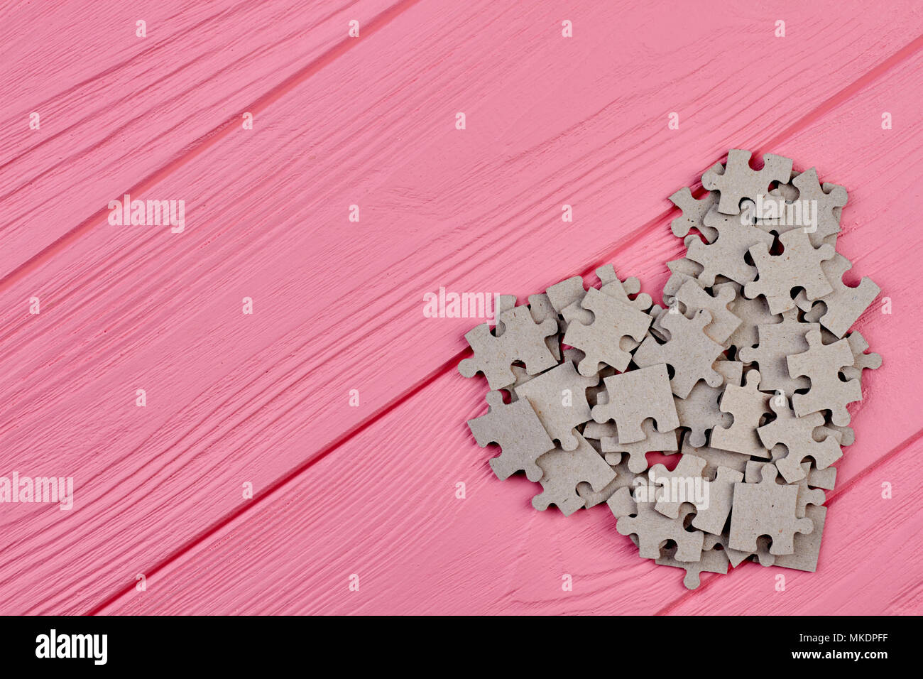 Heart shape from cardboard puzzles. Heart made from puzzles on wooden ...