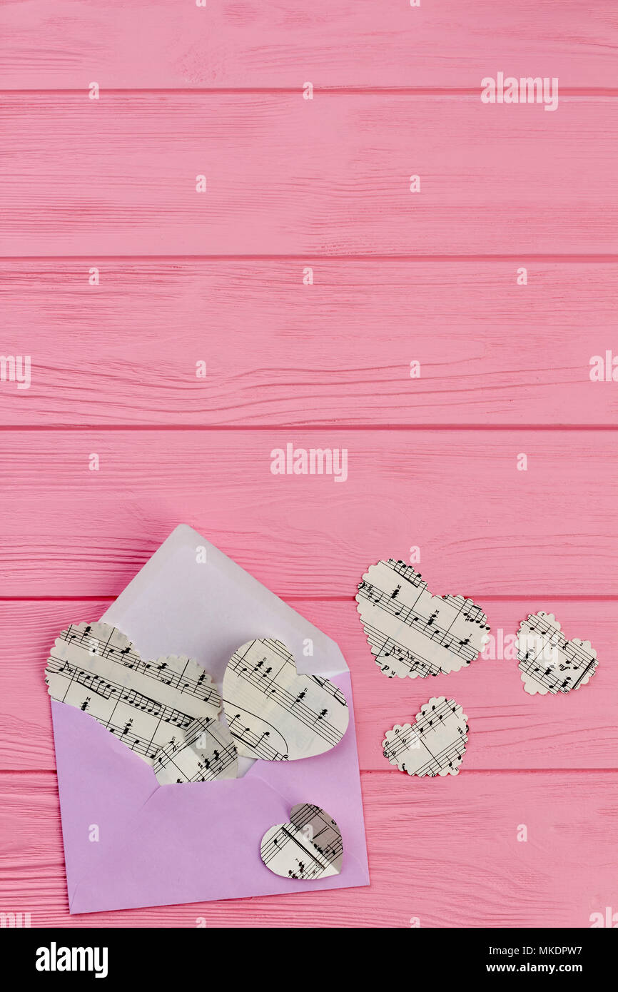 Envelope and paper hearts, top view. Opened envelope and hearts with ...