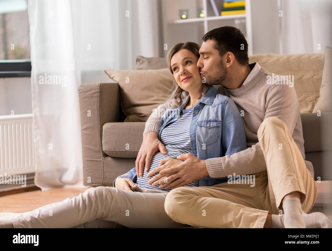man kissing and hugging pregnant woman at home Stock Photo - Alamy