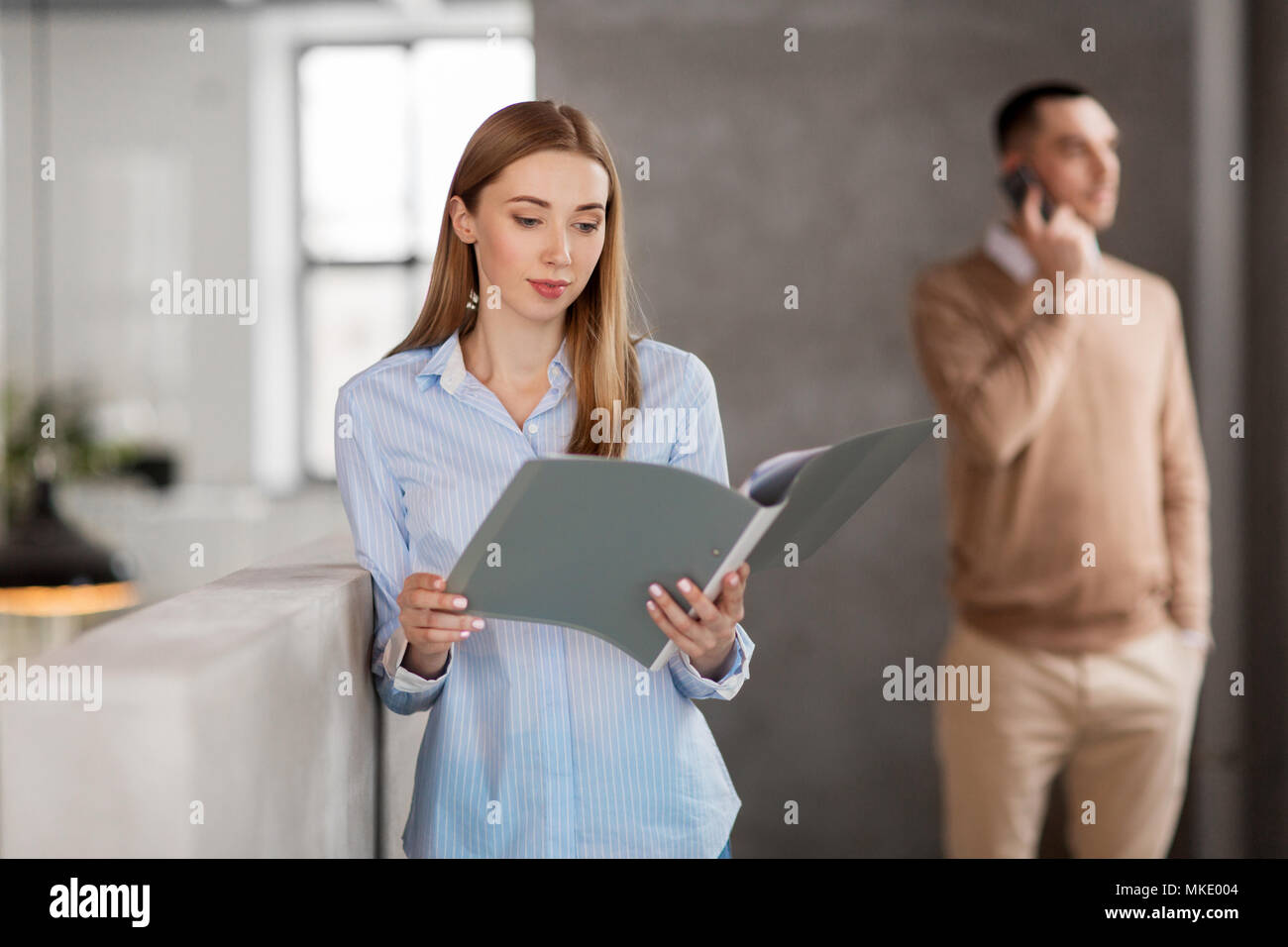 female office worker with folder Stock Photo - Alamy