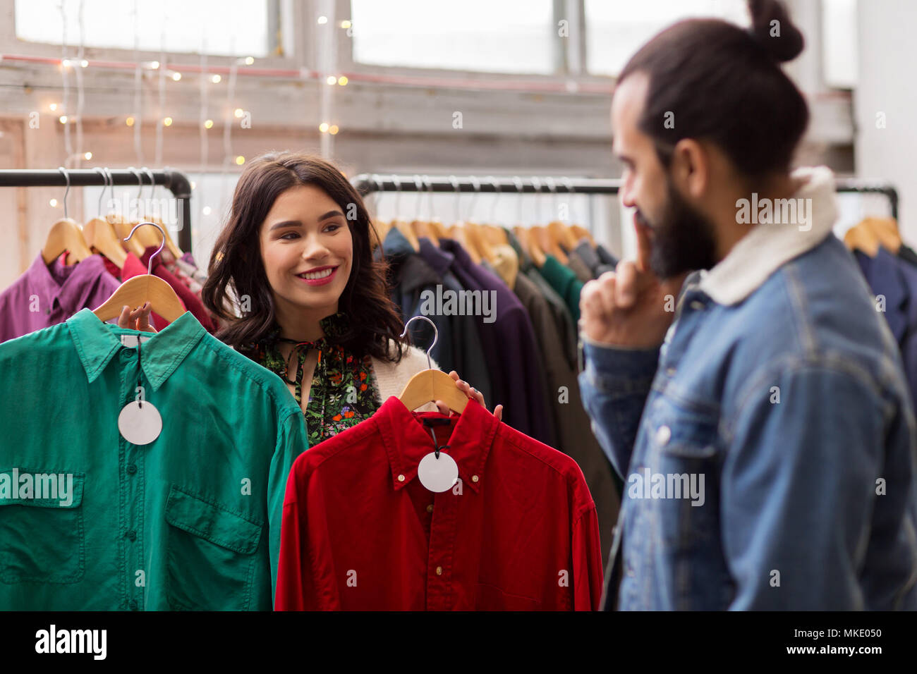 couple choosing clothes at vintage clothing store Stock Photo - Alamy