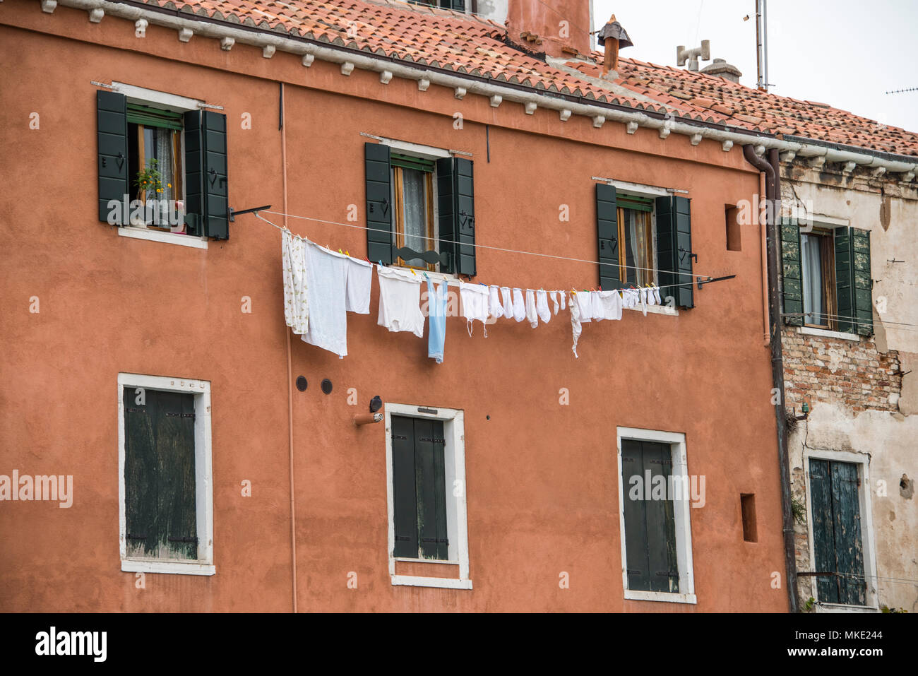 Laundry hanging between windows on a building near Arsenal, Venice ...
