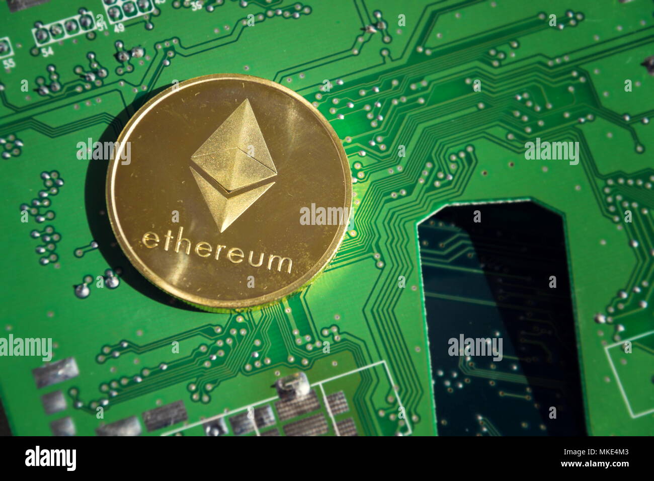 Golden ethereum coin lying on computer motherboard, cryptocurrency ...