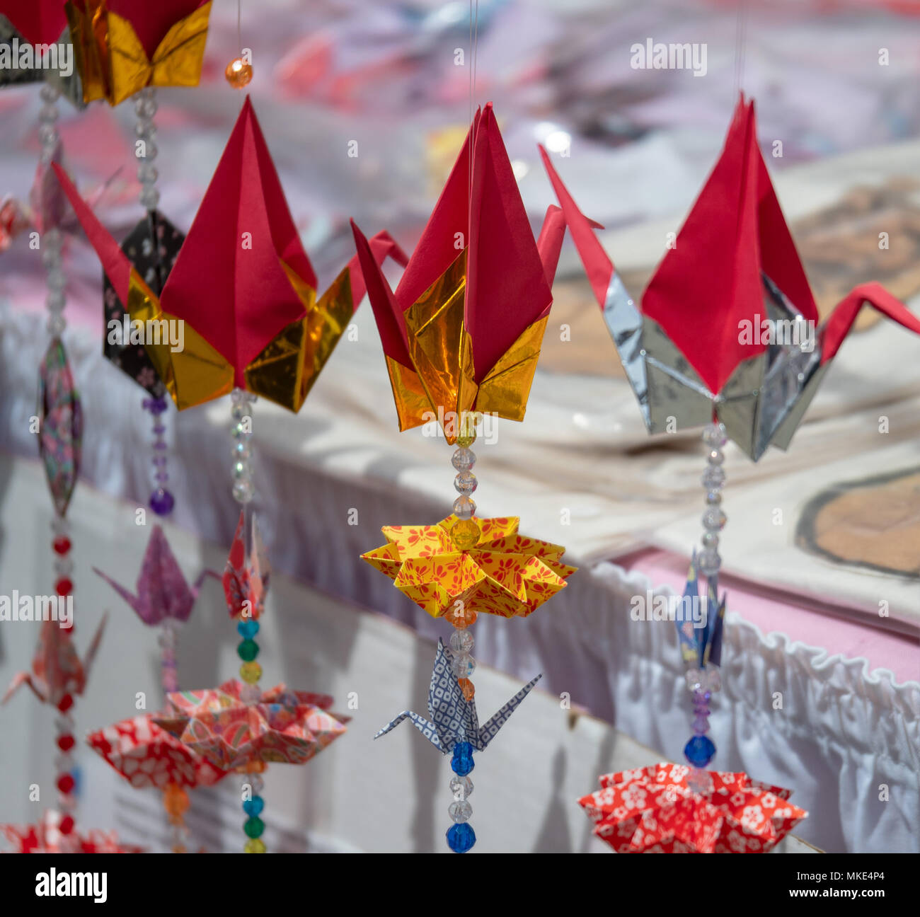 Suspended crane origami figures decorating an outdoor market in the ...