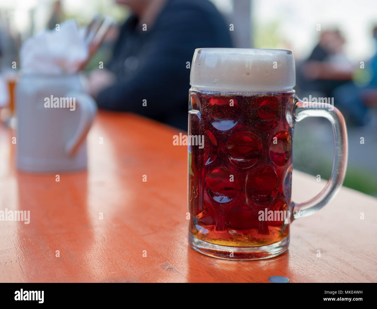 German beer mug on table at an outdoor beer garden Stock Photo - Alamy