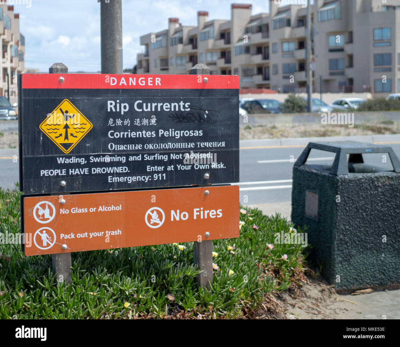 Rip current warning sign for an ocean area in multiple languages Stock ...