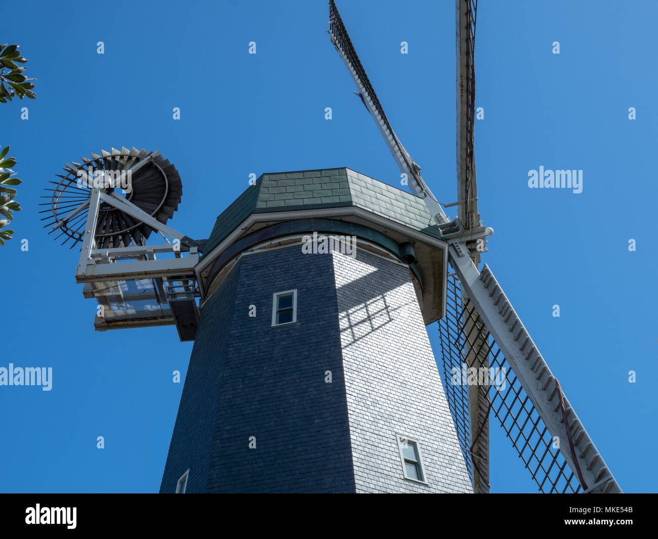 A side view of a windmill rotating on a cloudless day Stock Photo - Alamy
