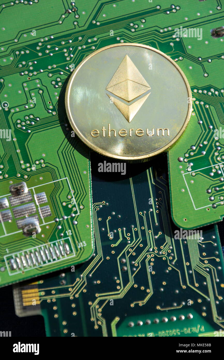 Golden ethereum coin lying on computer motherboard, cryptocurrency ...