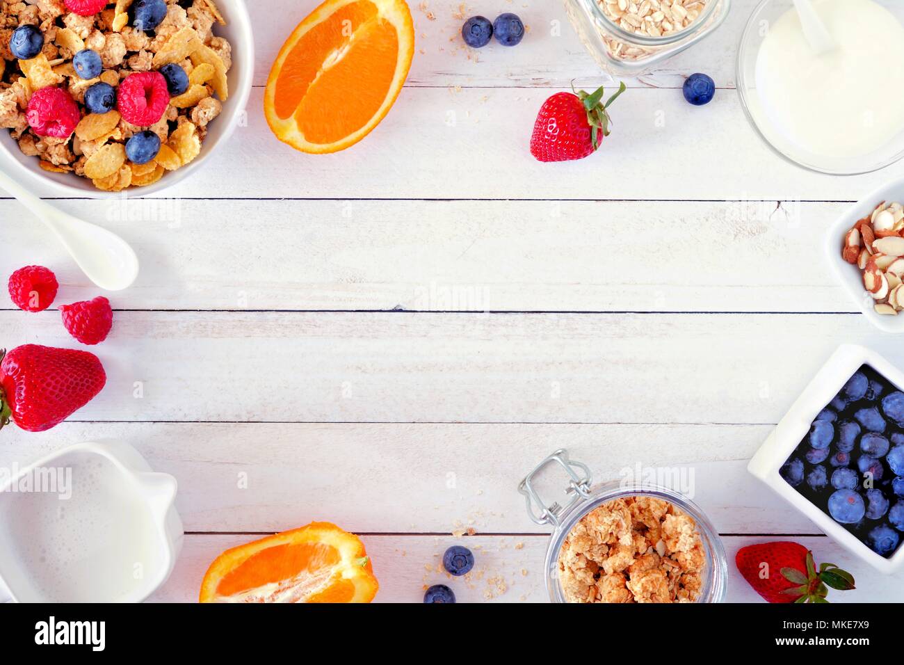 Ingredients for a healthy breakfast forming a frame over a white wood ...