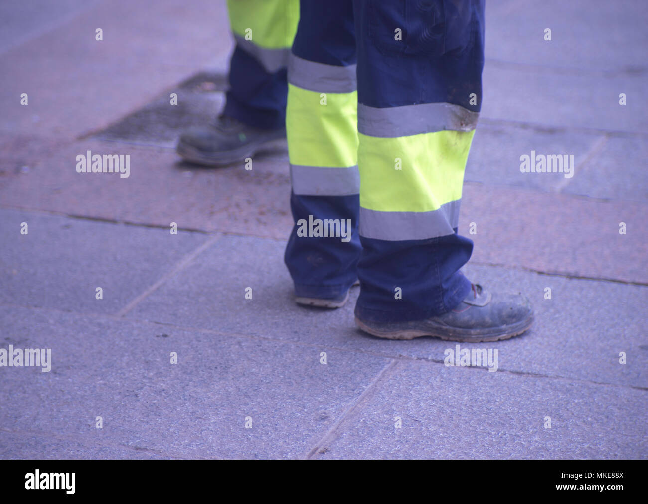 Municipal workers on sidewalk pavement standing in work uniform with ...